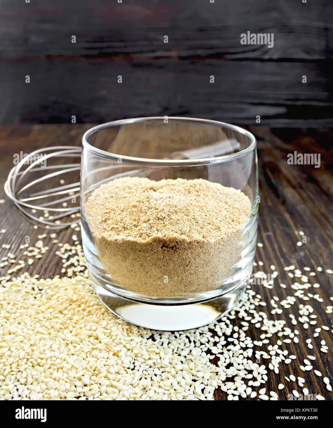 Flour sesame in glassful on dark board Stock Photo - Alamy