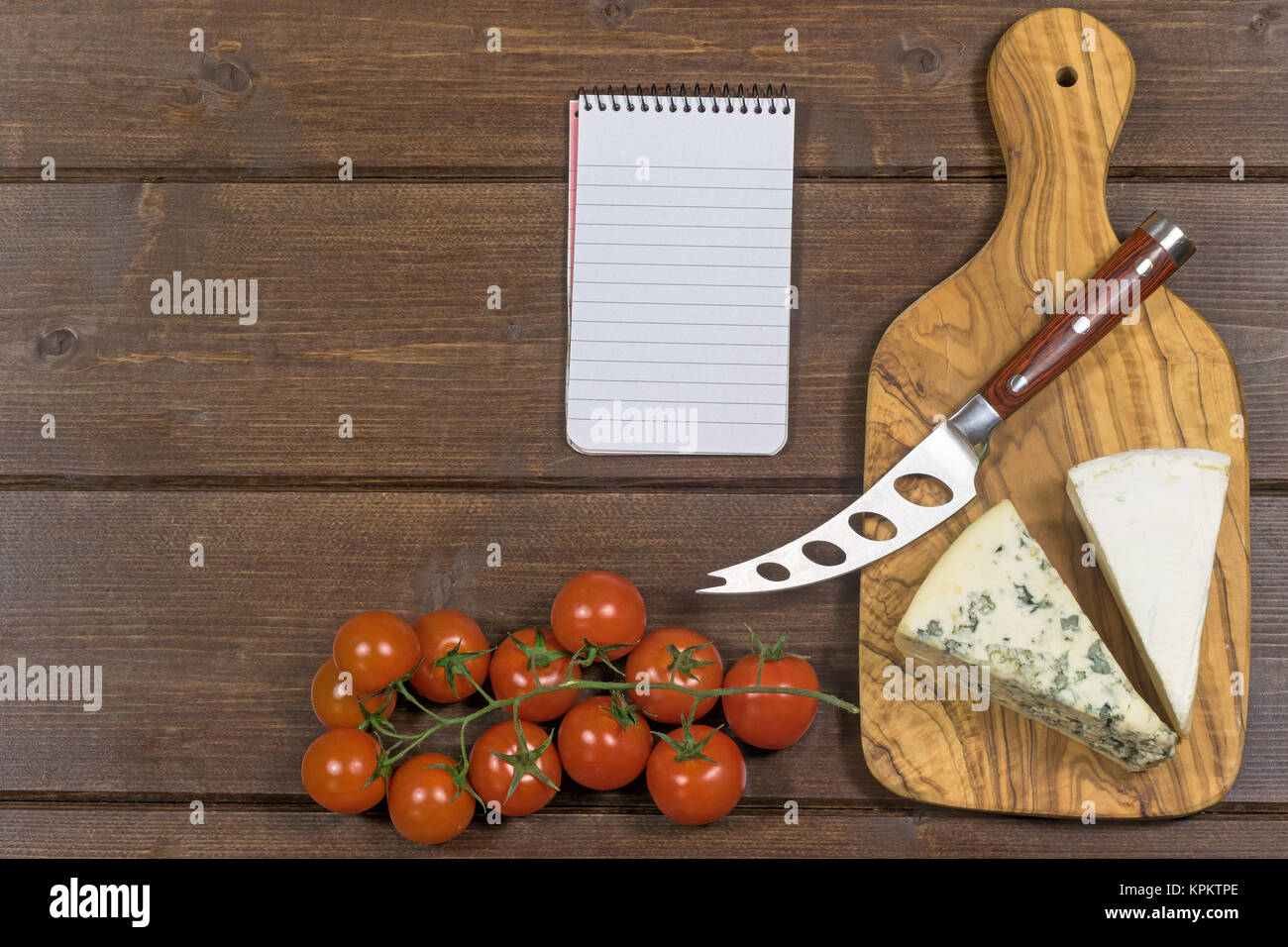 Cheese, tomatoes and paper notebook Stock Photo - Alamy