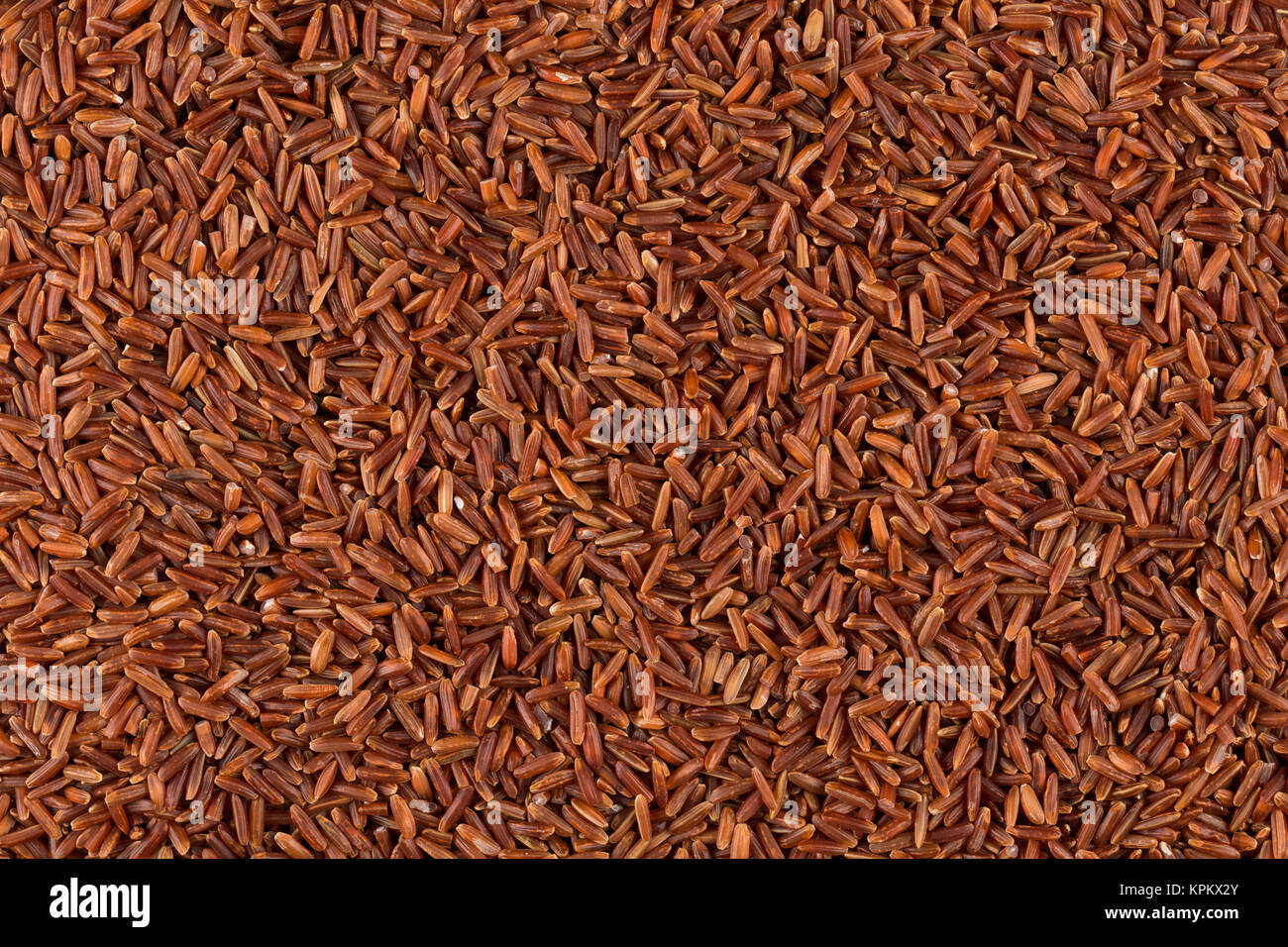 Raw red rice Stock Photo - Alamy