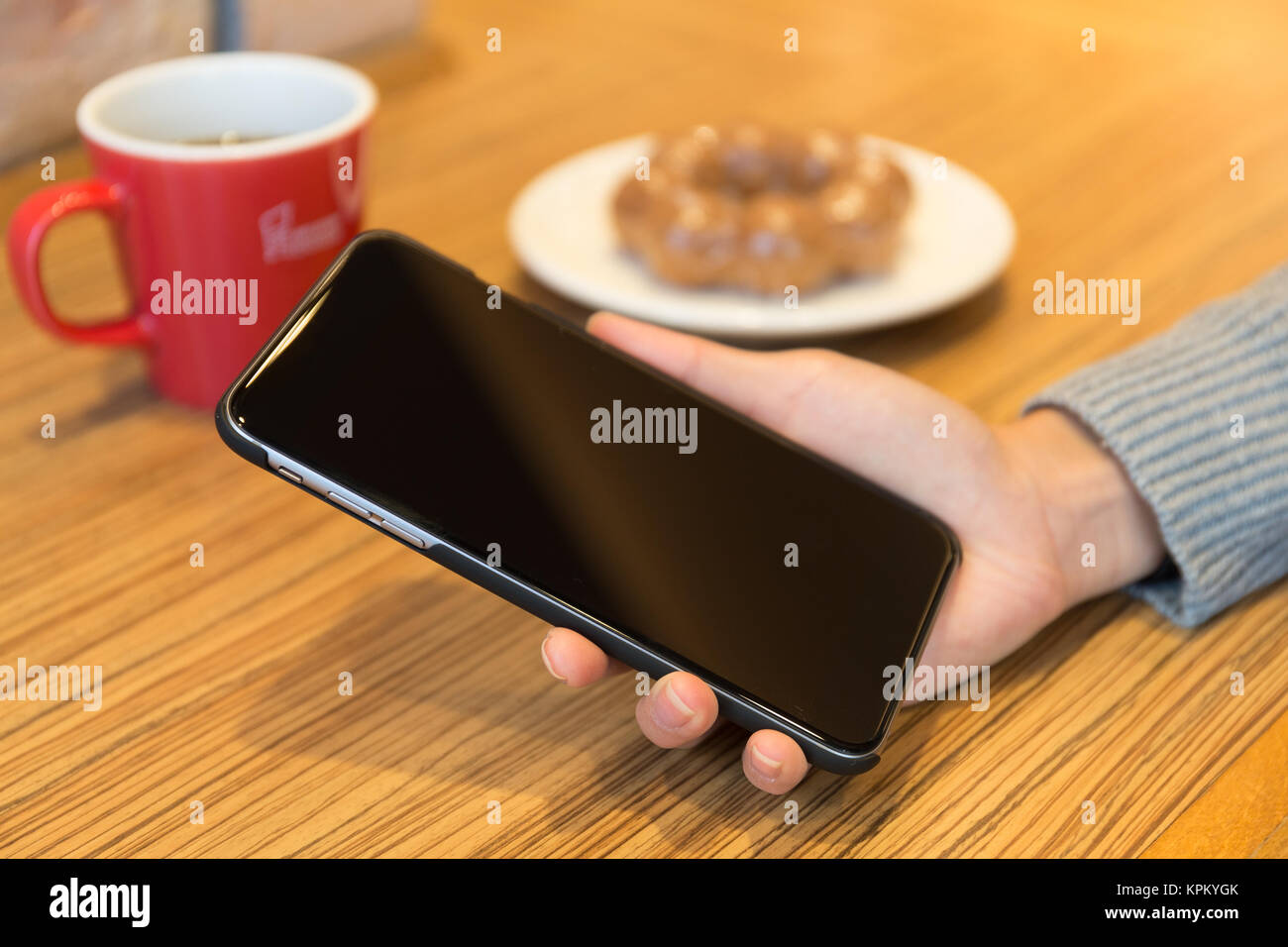 Woman using mobile phone at coffee shop Stock Photo - Alamy