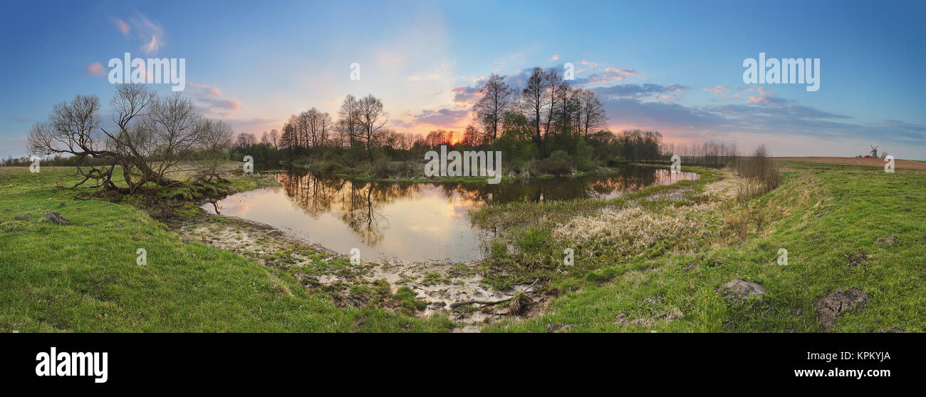 Sunny spring sunset landscape. River in a forest Stock Photo - Alamy