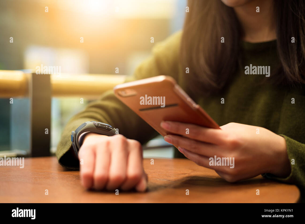 Woman connect smart watch with mobile phone Stock Photo - Alamy