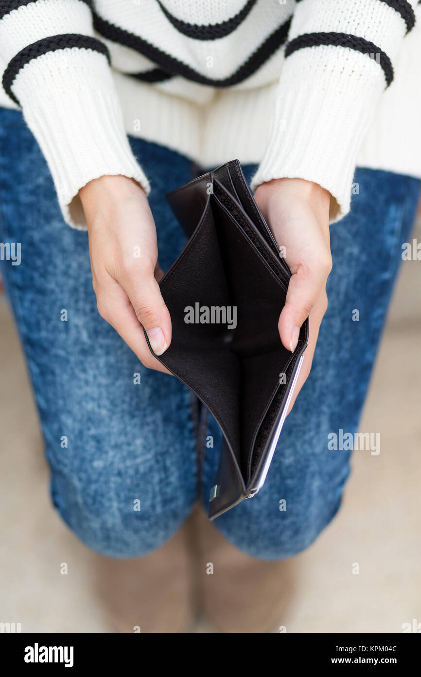 Woman with an empty wallet Stock Photo - Alamy