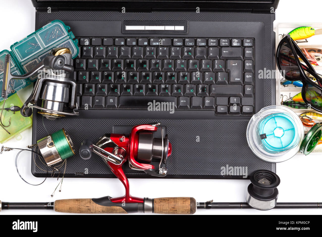 fishing tackles on keyboard a black notebook Stock Photo - Alamy