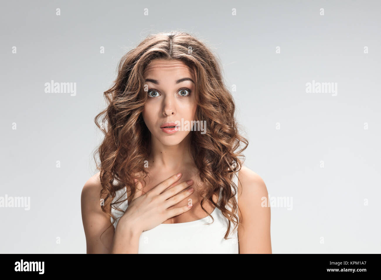 Portrait of young woman with shocked facial expression Stock Photo - Alamy