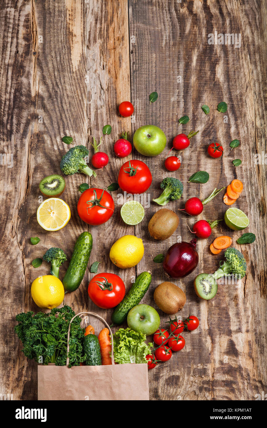 The vegetables from a paper bag on wooden table Stock Photo - Alamy