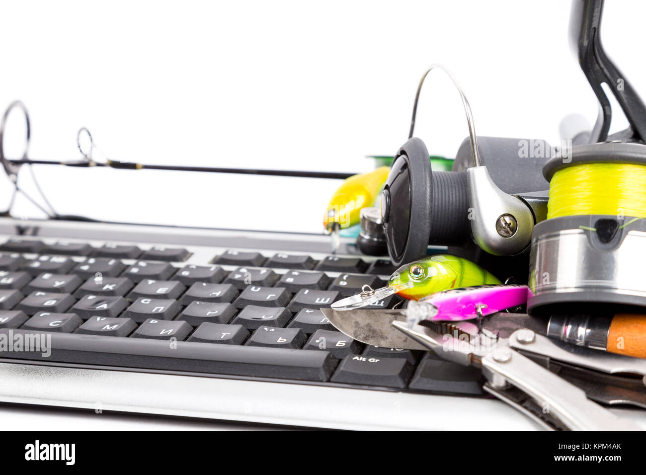 fishing tackles on computer keyboard Stock Photo - Alamy