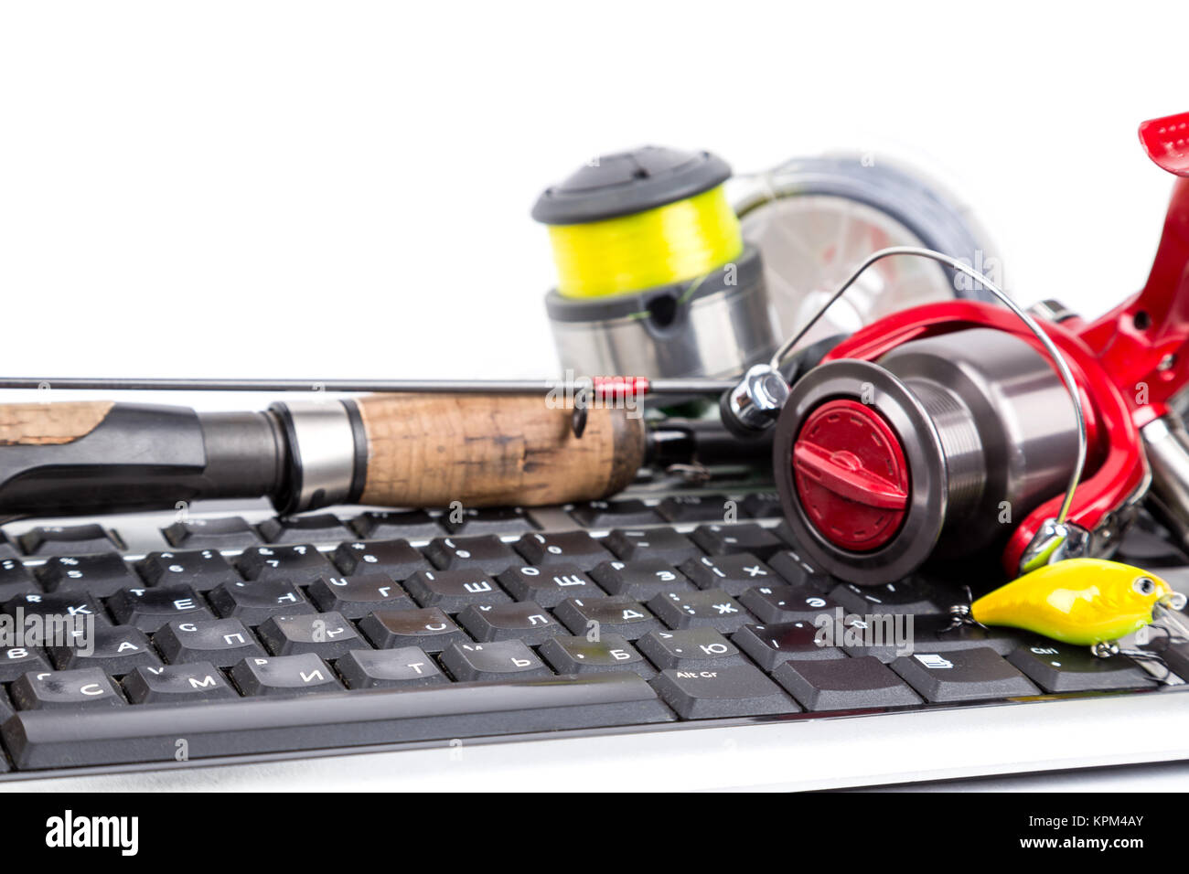 fishing tackles on computer keyboard Stock Photo - Alamy