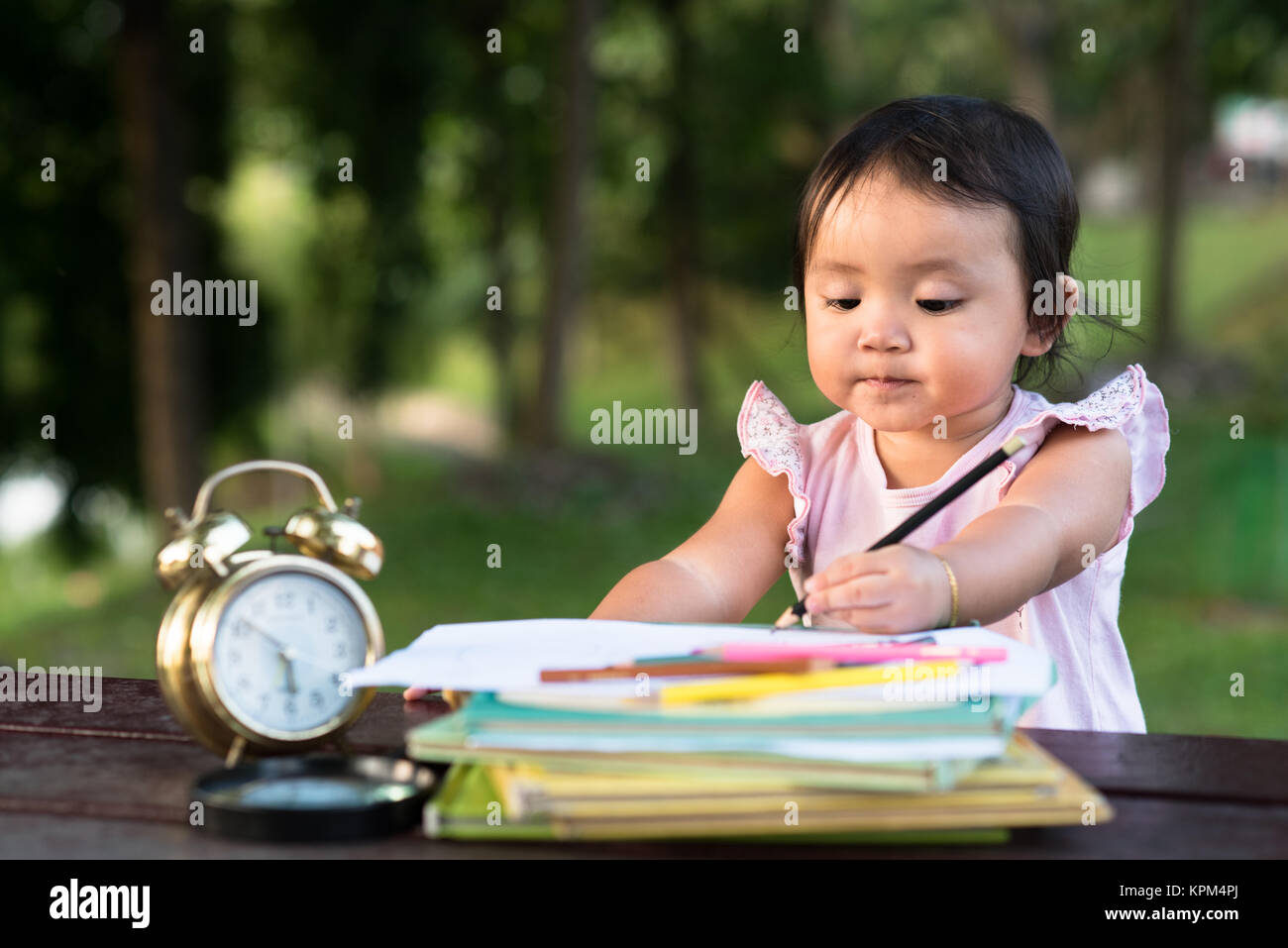little baby toddler drawing using left hand at park. left handed ...