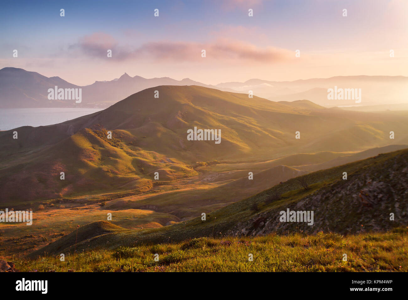 Spring sunset in the mountains. Seacoast and hills Stock Photo - Alamy