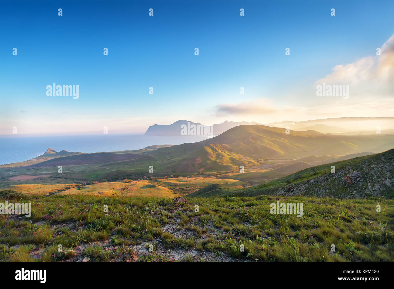 Spring sunset in the mountains. Seacoast and hills Stock Photo - Alamy