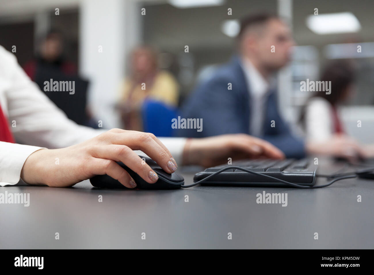 Close up of female hand on mouse while typing on keyboard Stock Photo ...