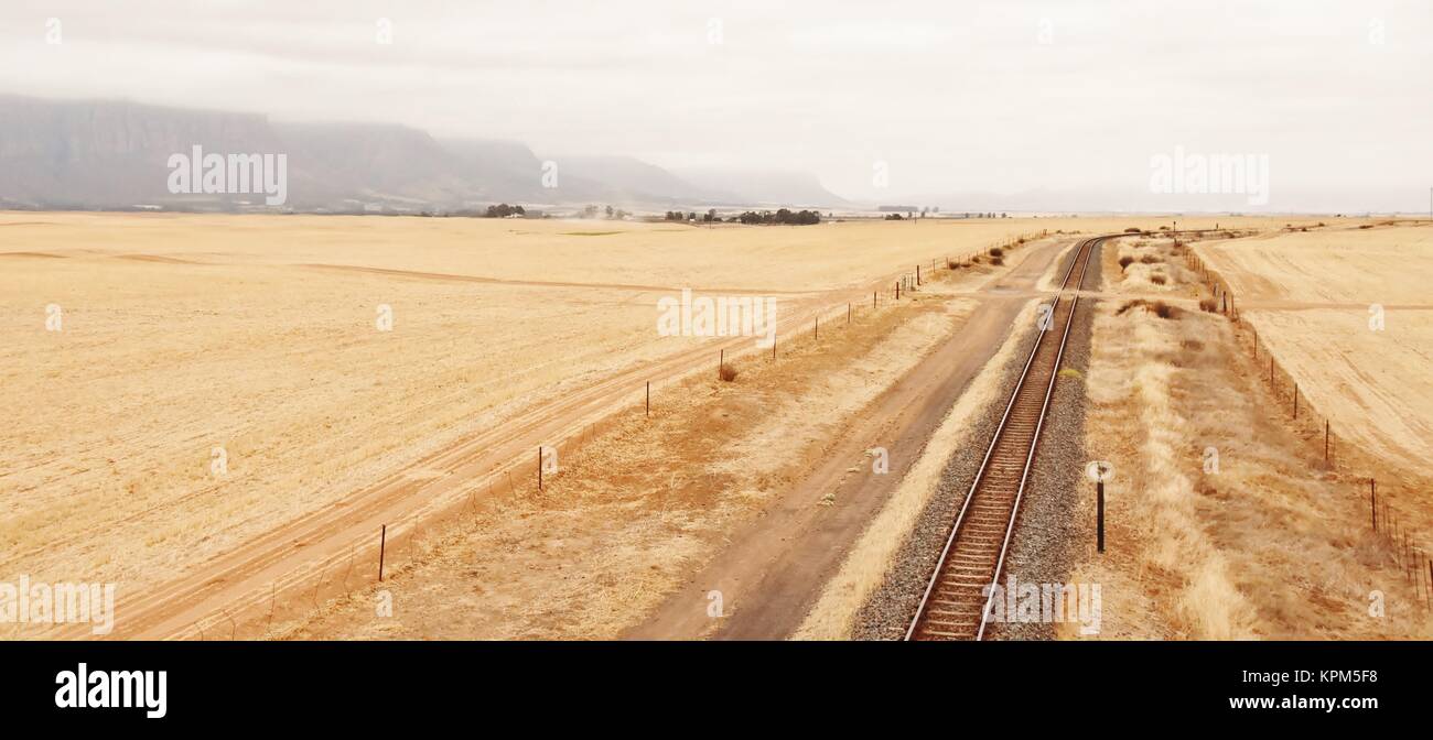 Landscape with dry farm land and a railway line Stock Photo - Alamy