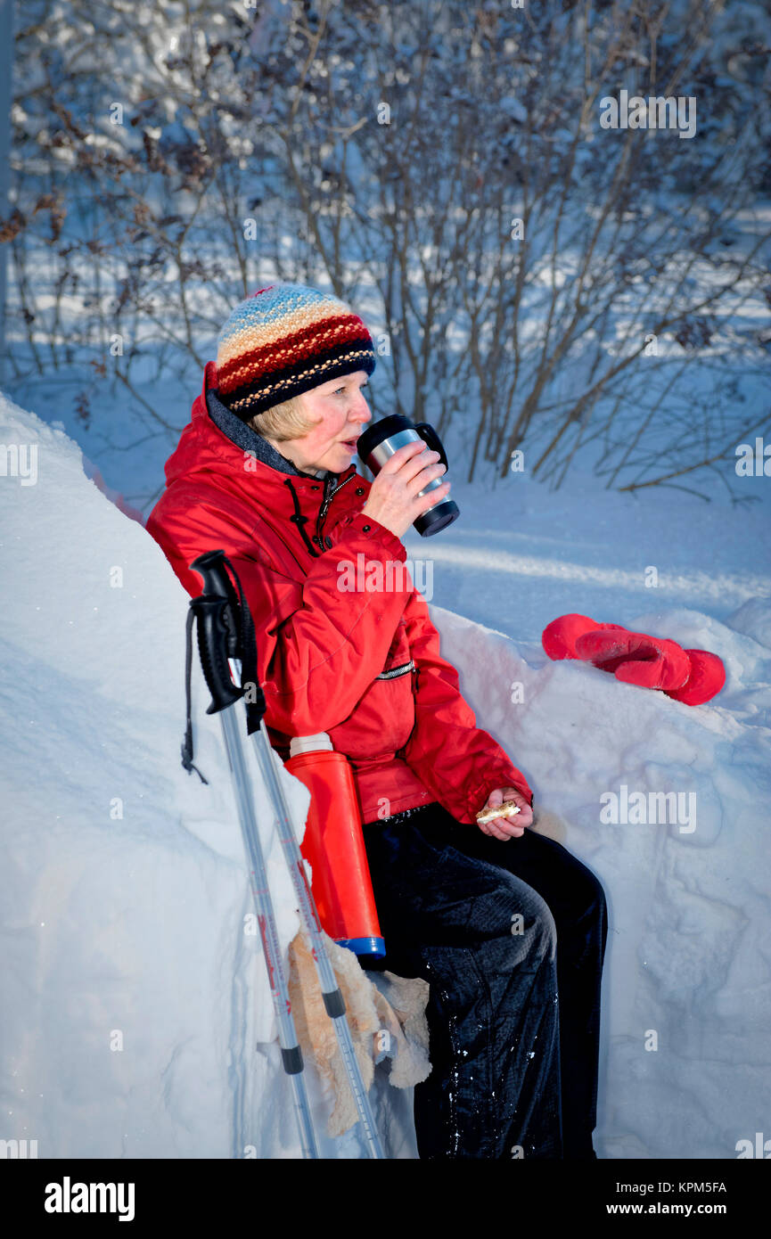 Woman drinking coffe in the snow Stock Photo - Alamy