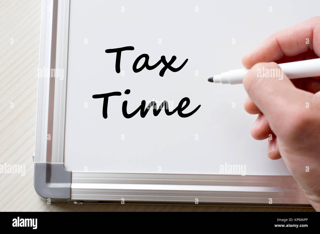 Tax time written on whiteboard Stock Photo - Alamy