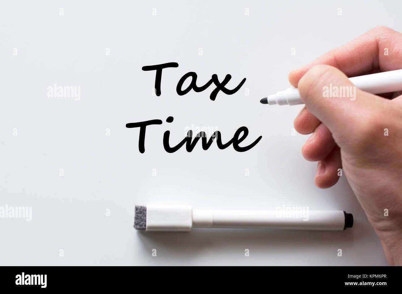 Tax time written on whiteboard Stock Photo - Alamy