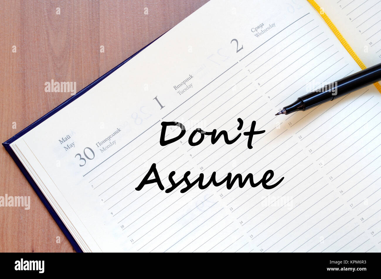 Don't assume write on notebook Stock Photo - Alamy