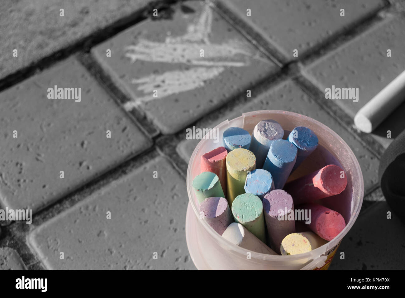 Children drawing on a pavement with chalk hi-res stock photography and ...