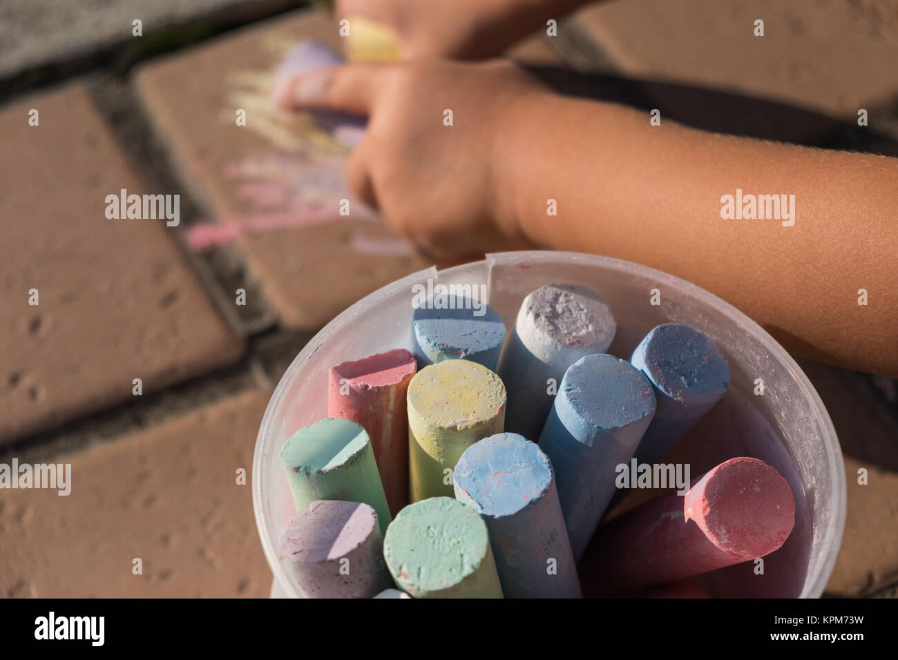 Children drawing on a pavement with chalk hi-res stock photography and ...