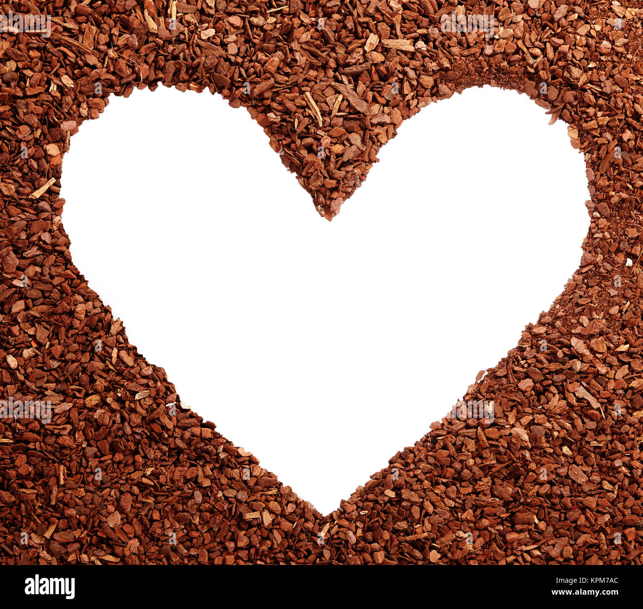 Blank white heart symbol with copy space surrounded by pine bark mulch ...