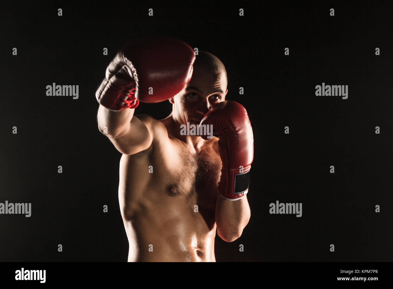 The young man kickboxing on black Stock Photo - Alamy