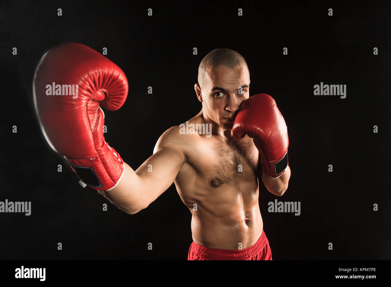 The young man kickboxing on black Stock Photo - Alamy