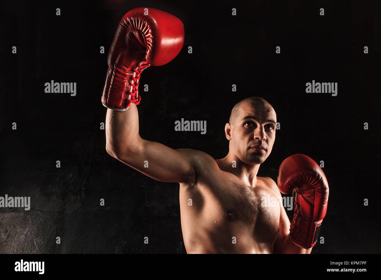 The young man kickboxing on black Stock Photo - Alamy