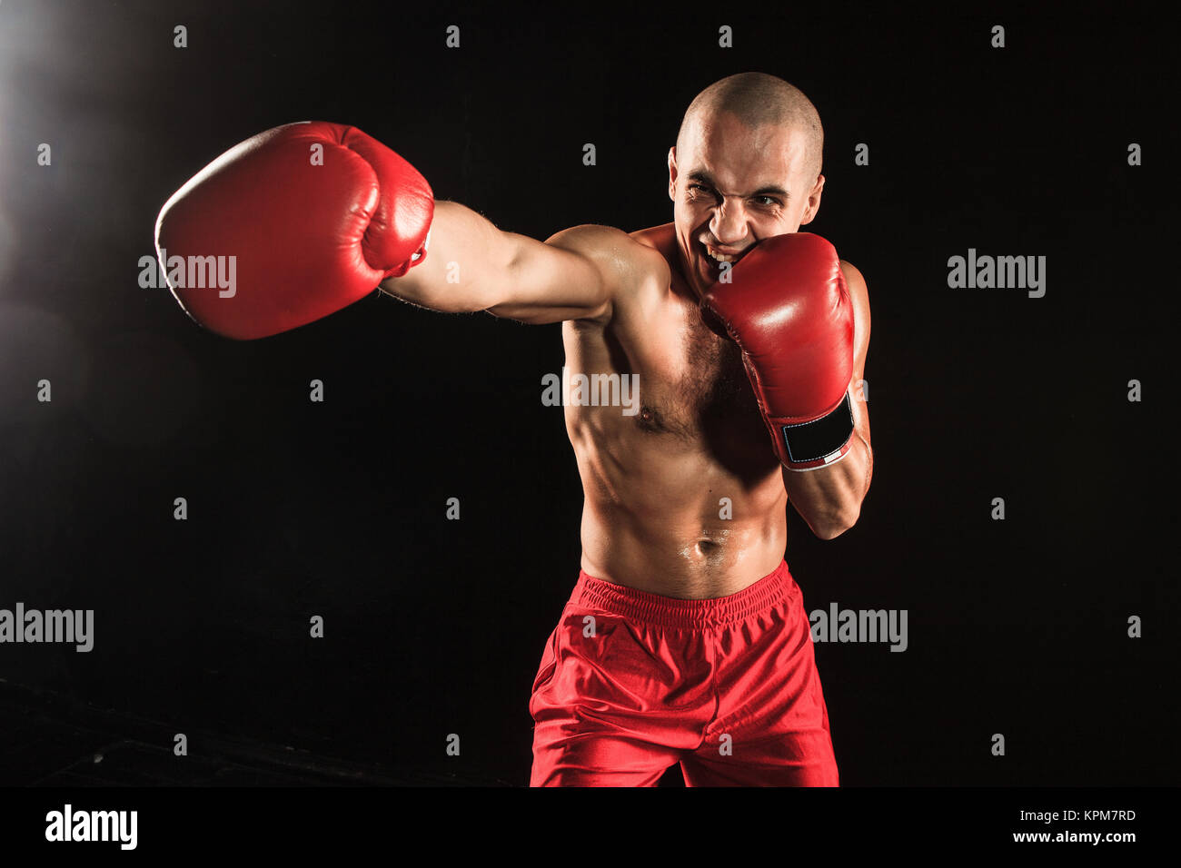 The young man kickboxing on black Stock Photo - Alamy