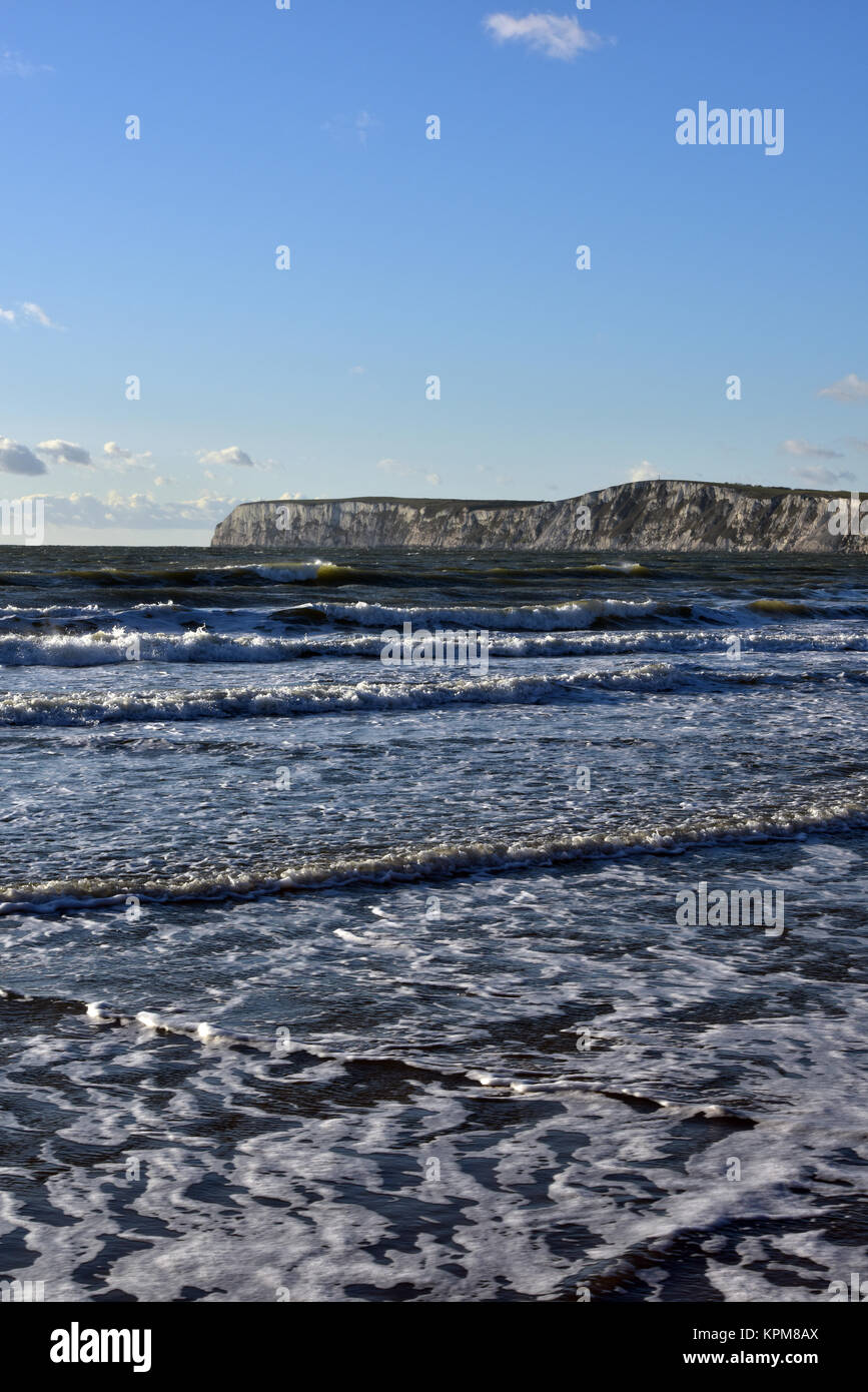Waves breaking on the shoreline and beach causing surf to roll into the ...