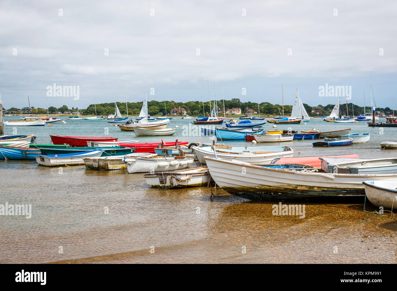 Rowing boats moored on the shoreline at West Itchenor, a small village ...