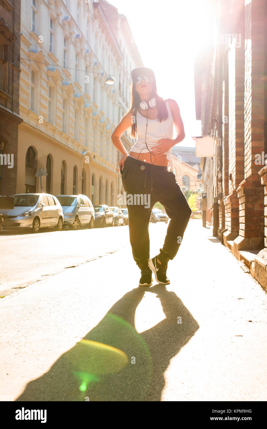 A beautiful young Hip Hop Rapper girl with Headphones in a urban ...