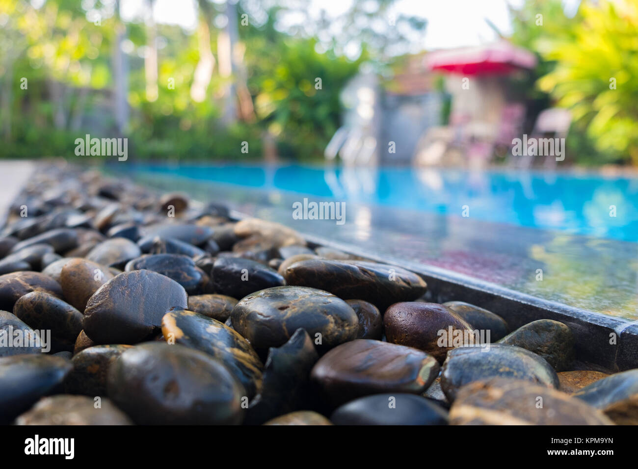 Edge of swimming pool with blue mosaic tiles of the pool. poolside ...