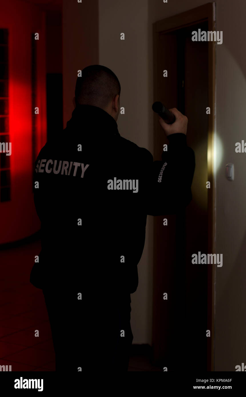 Security man, checks in the dark with flashlight Stock Photo - Alamy