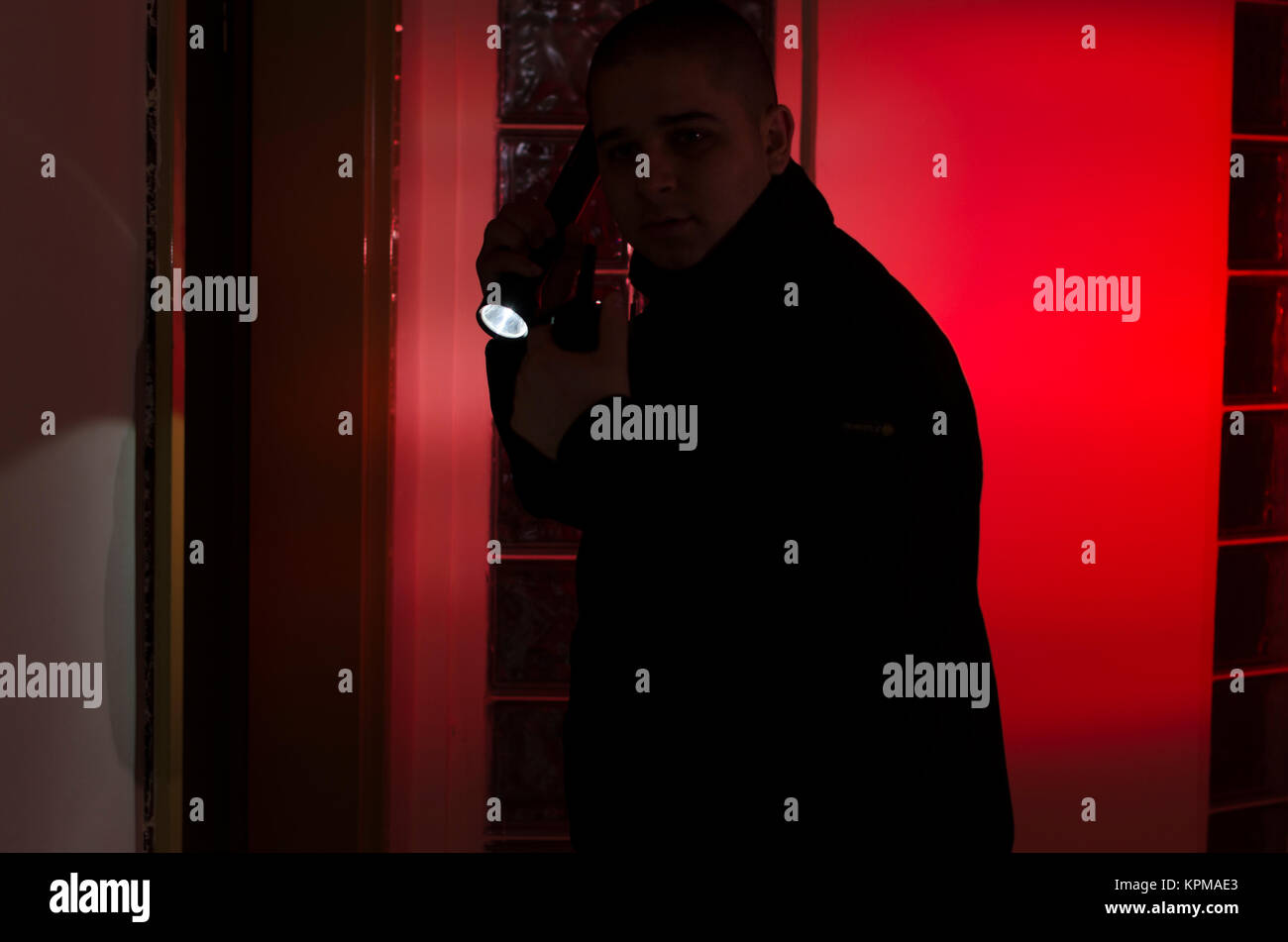 Security man, checks in the dark with flashlight Stock Photo - Alamy