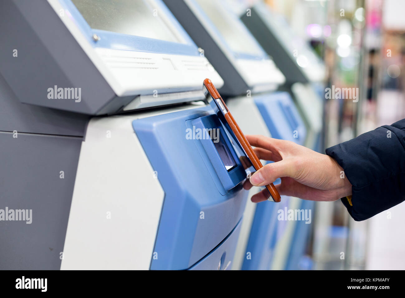 Woman pay with cellphone by NFC on ticketing system Stock Photo - Alamy
