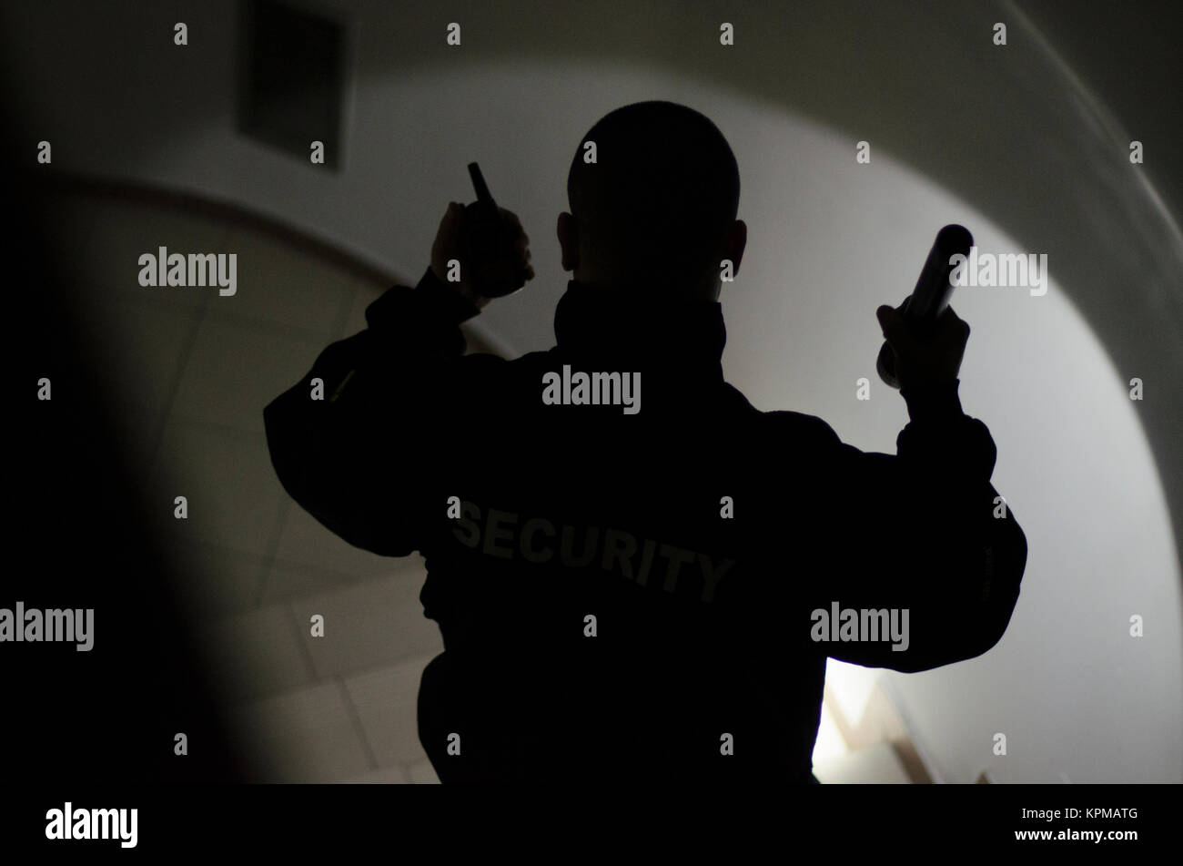 Security man, checks in the dark with flashlight Stock Photo - Alamy