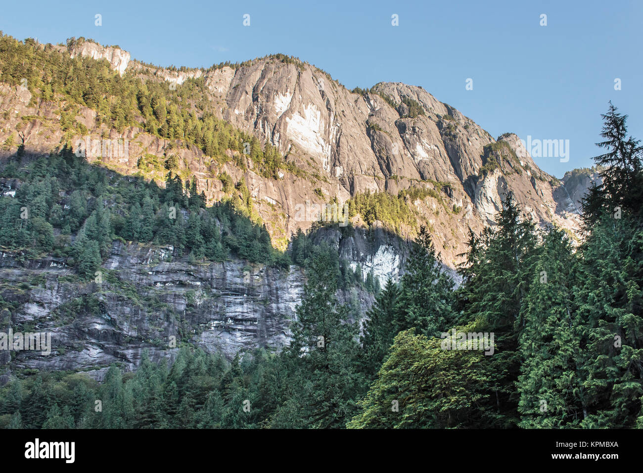 In Princess Louisa Inlet, morning sun lights up the mountain tops along ...