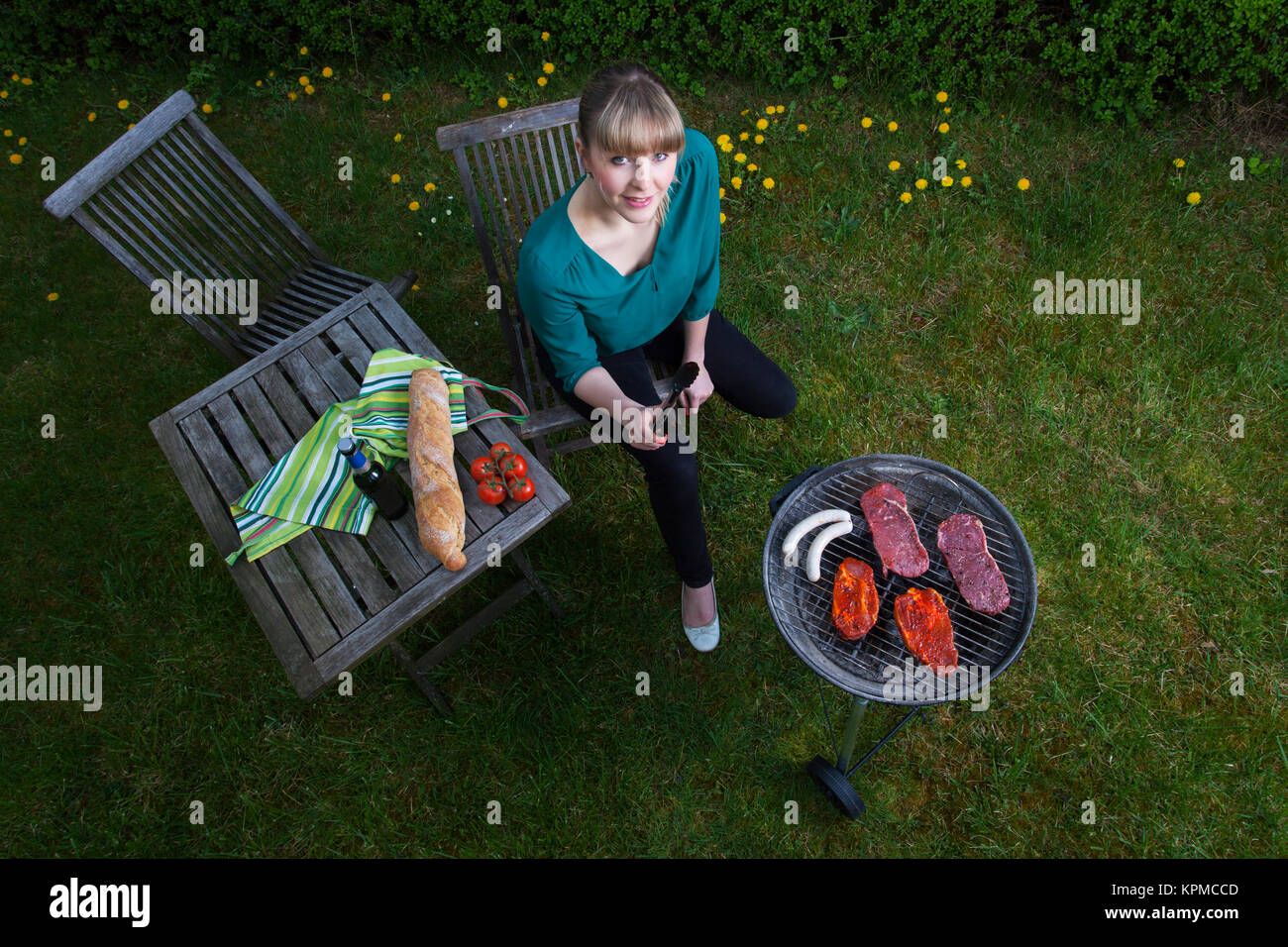 blonde woman barbecuing Stock Photo - Alamy