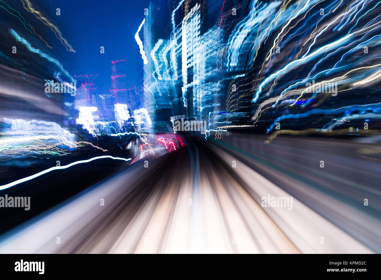 Speedy train passing though in city at night Stock Photo - Alamy