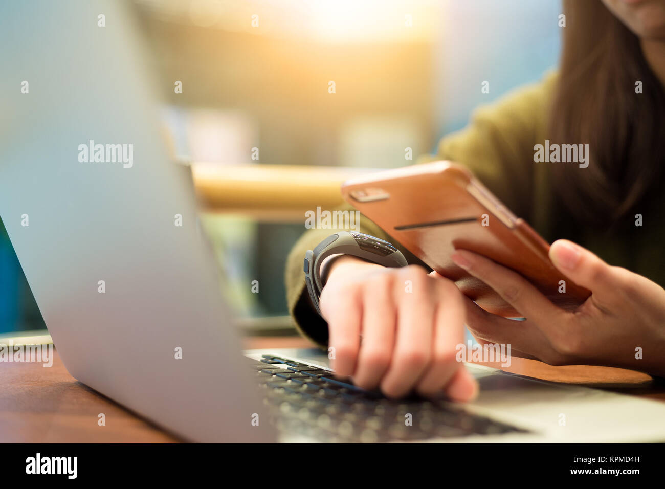 Woman connecting with smart watch and mobile phone Stock Photo - Alamy