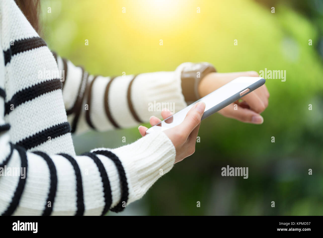 Woman connecting cellphone and smartwatch Stock Photo - Alamy
