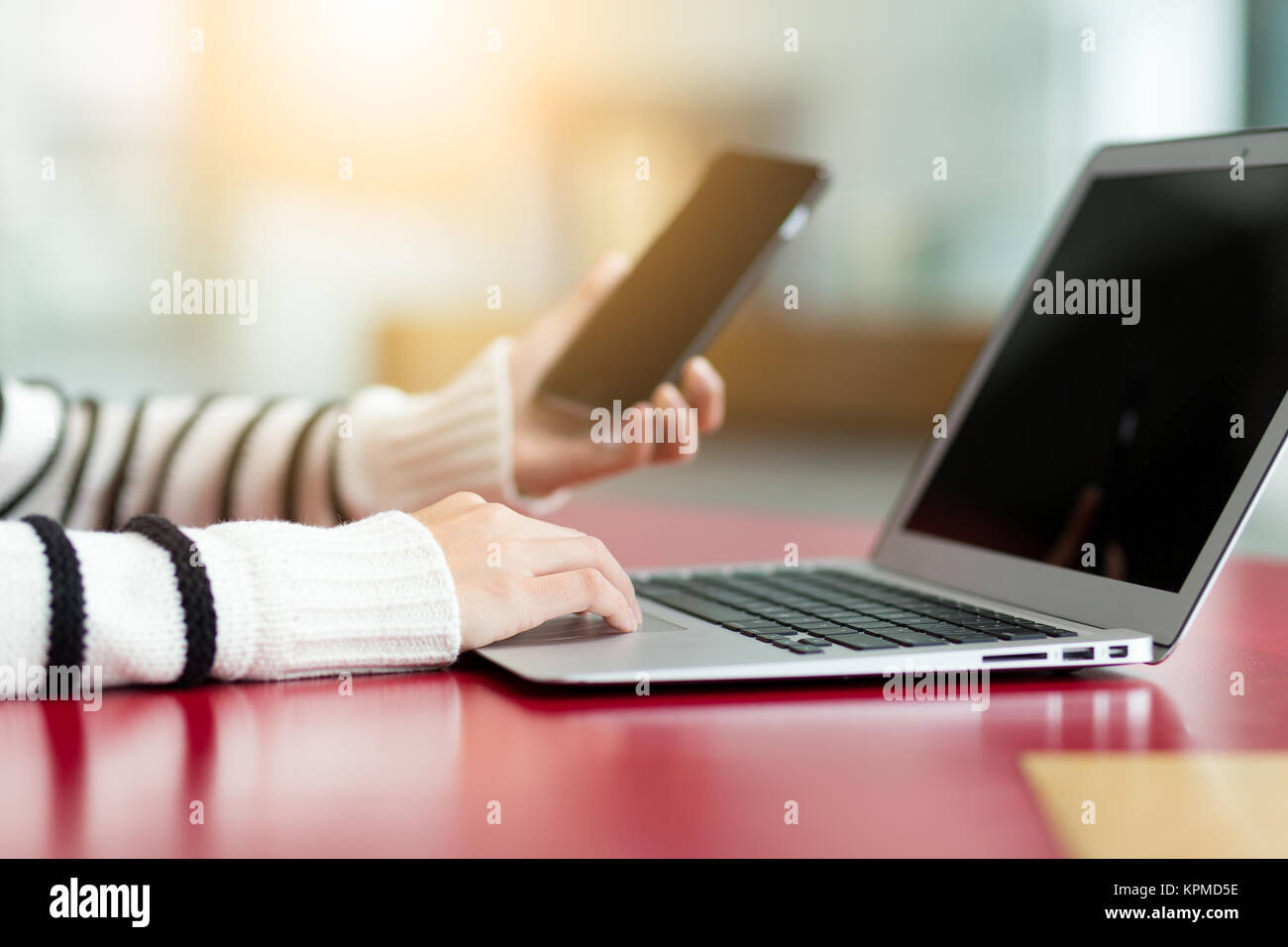 Woman use of laptop computer and cellphone Stock Photo - Alamy