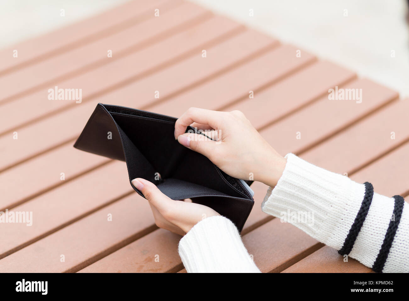Woman with empty wallet Stock Photo - Alamy