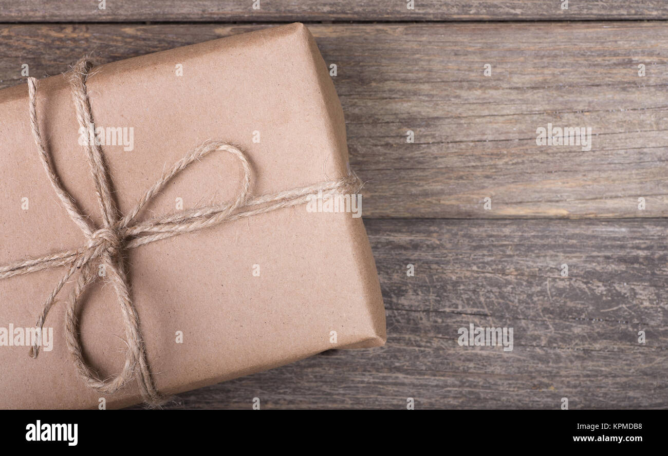 Closeup of a brown package tied with string on a wood background Stock ...