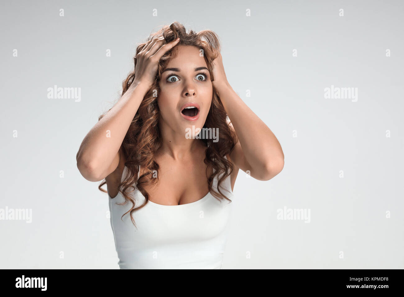 Portrait of young woman with shocked facial expression Stock Photo - Alamy