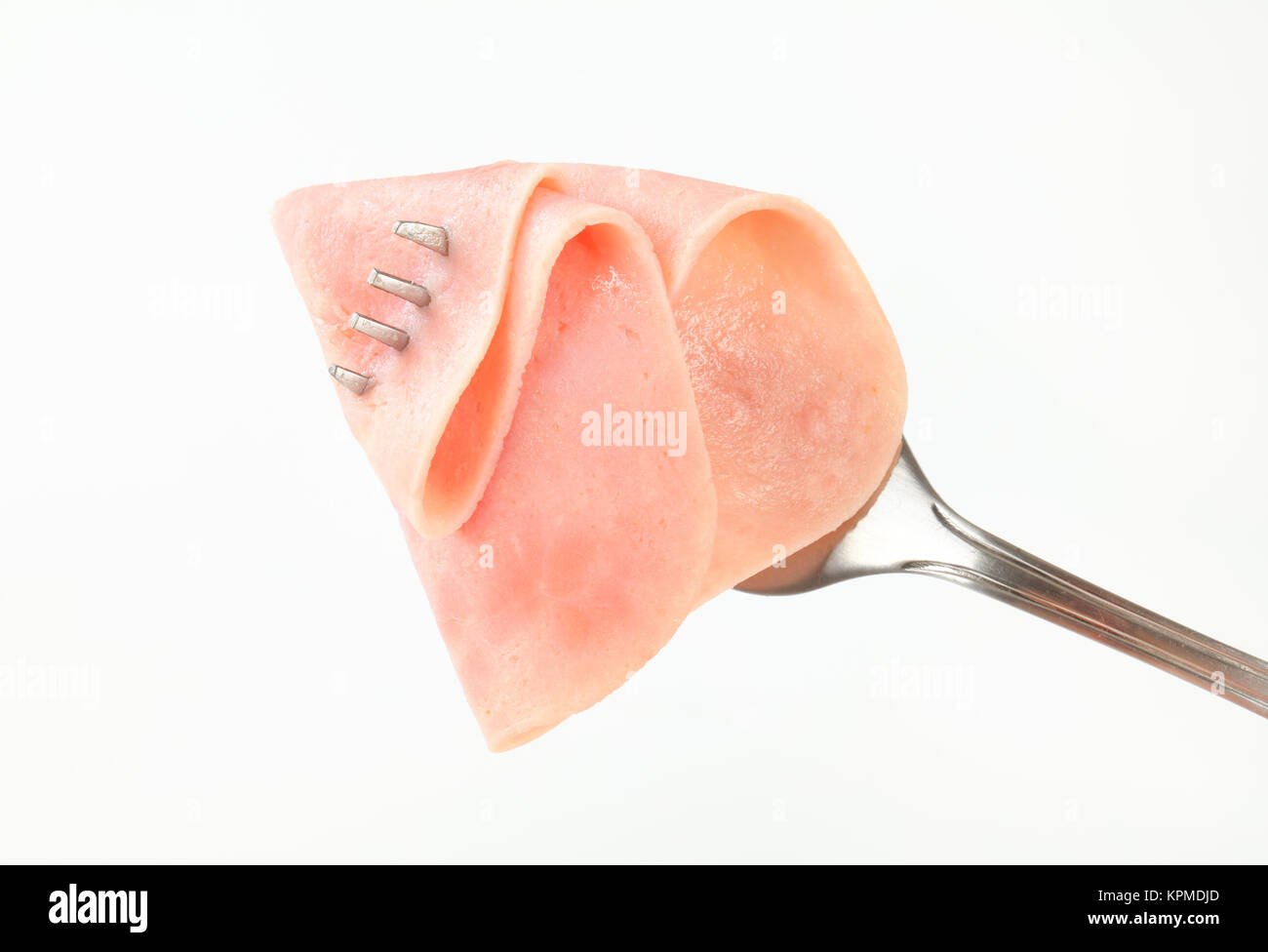 Slices of ham on fork Stock Photo - Alamy
