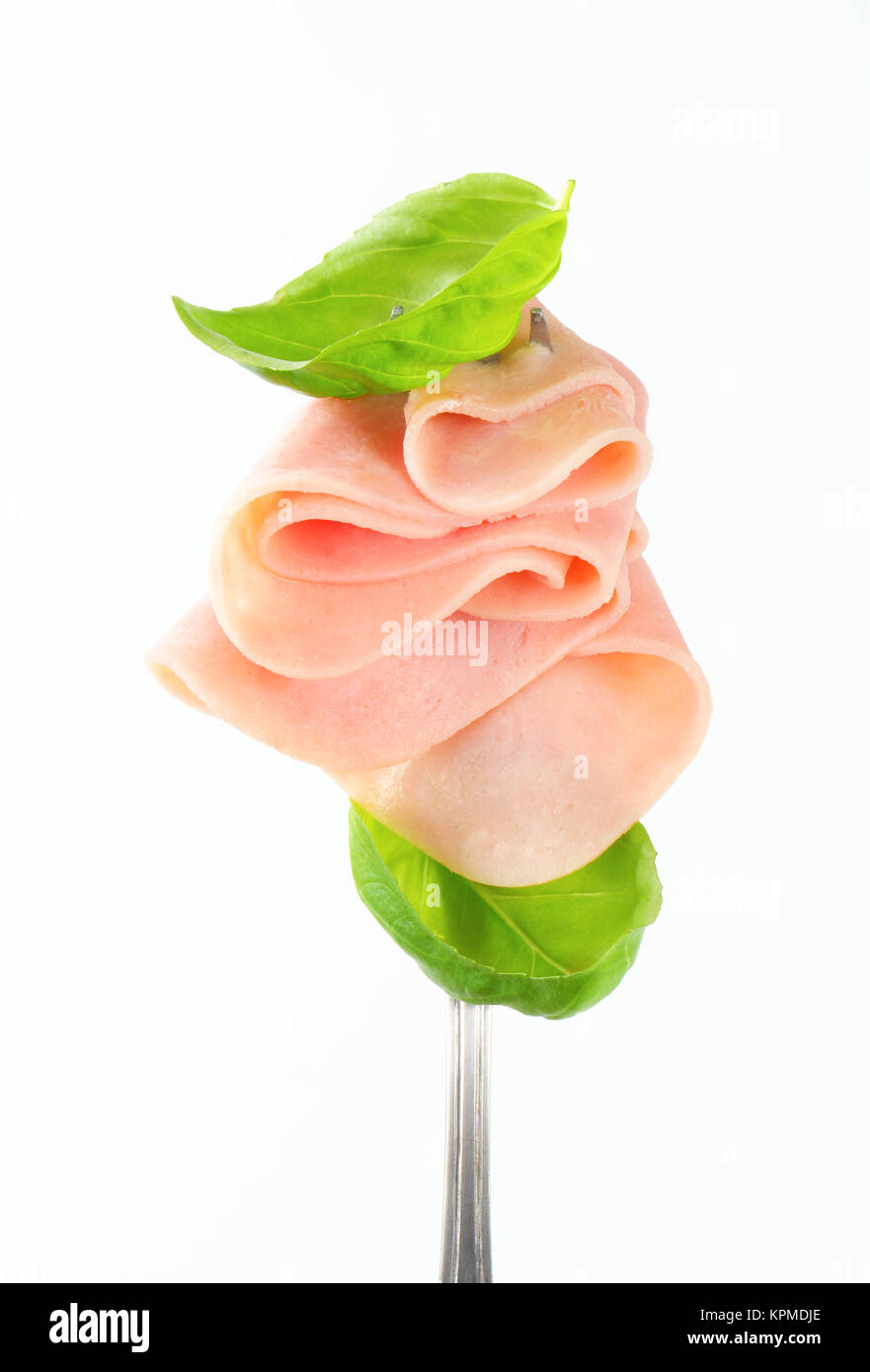 Slices of ham on fork Stock Photo - Alamy