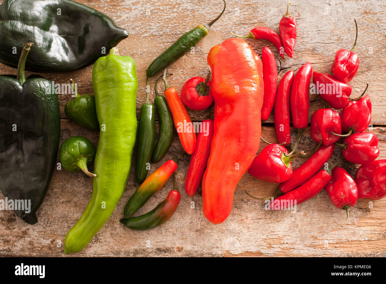 Colorful selection of spicy peppers on table Stock Photo - Alamy