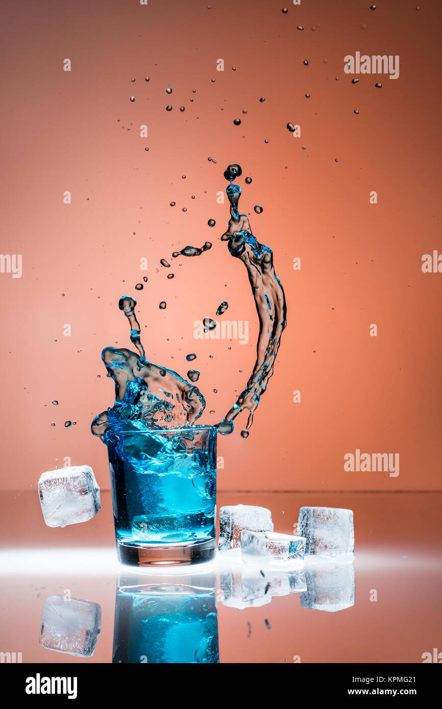 ice cube falling into glass Stock Photo - Alamy