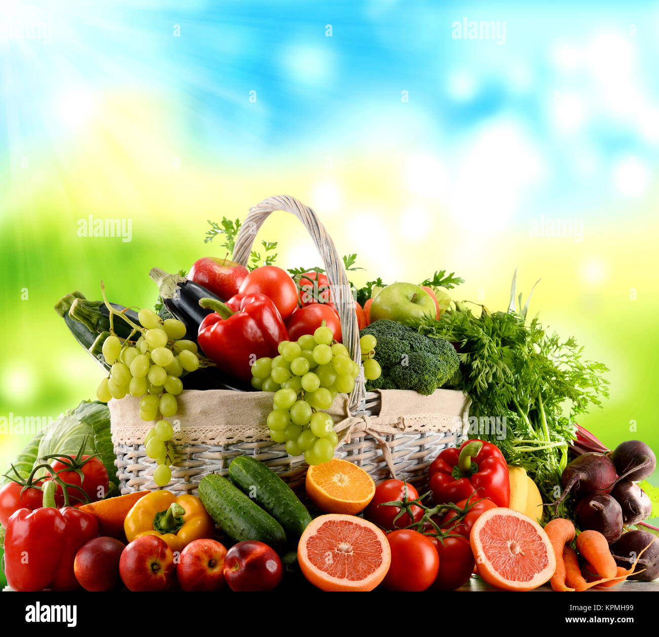 Variety of organic vegetables and fruits in wicker basket Stock Photo ...